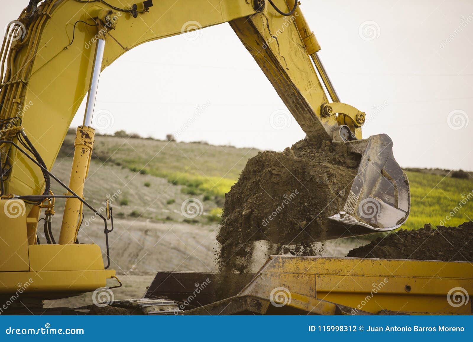 Excavator loading a truck. stock photo. Image of moving - 115998312