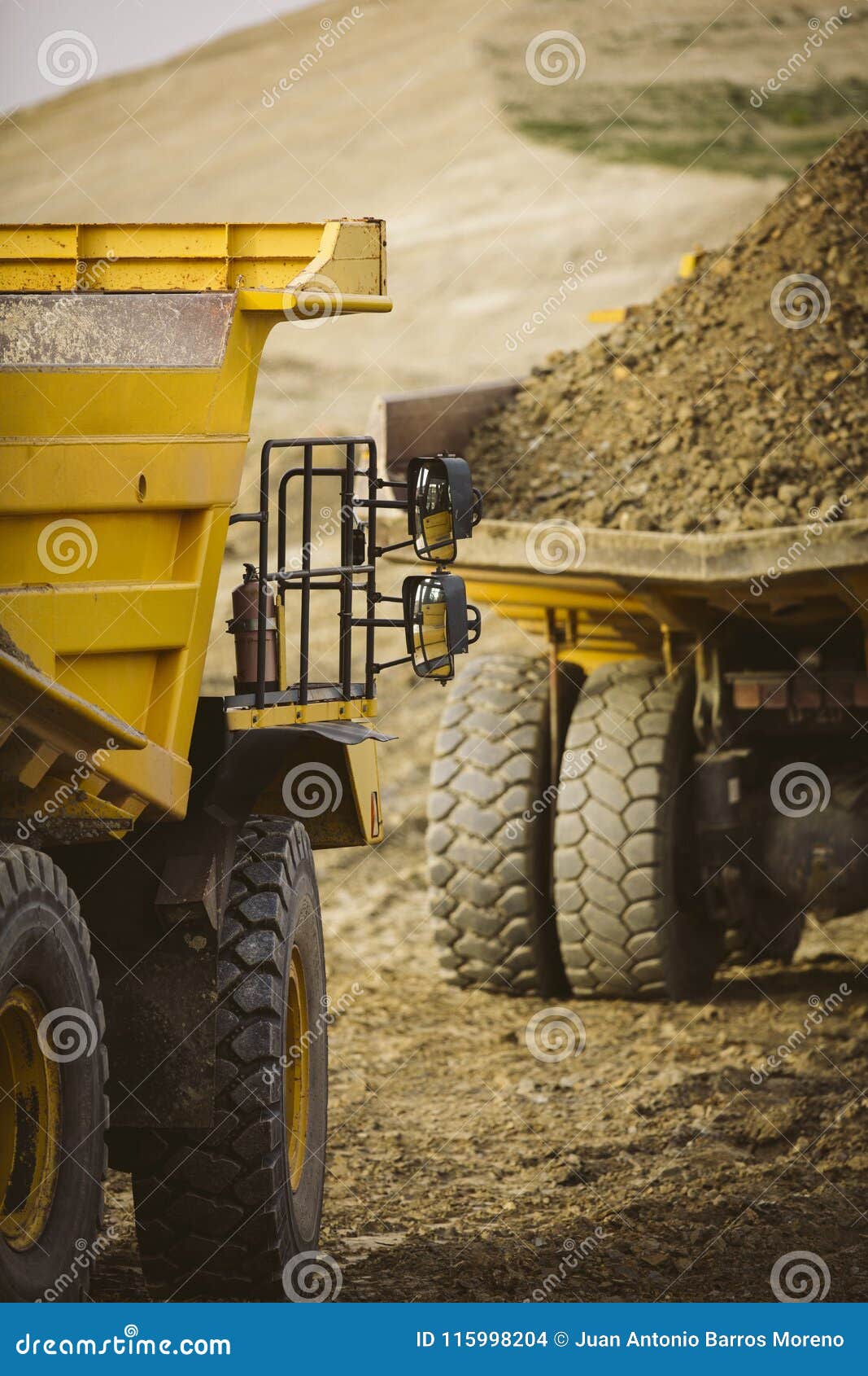 Excavator loading a truck. stock photo. Image of industrial - 115998204