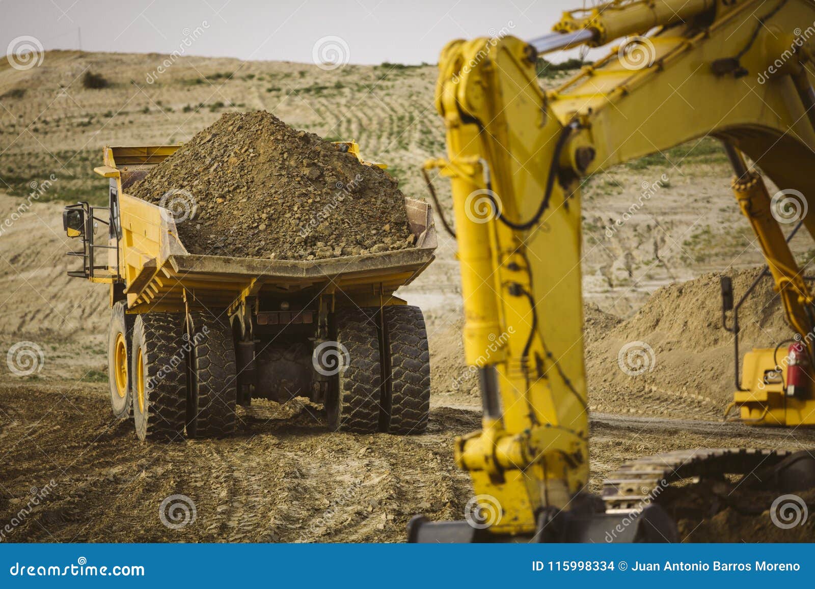 Excavator loading a truck. stock photo. Image of loader - 115998334