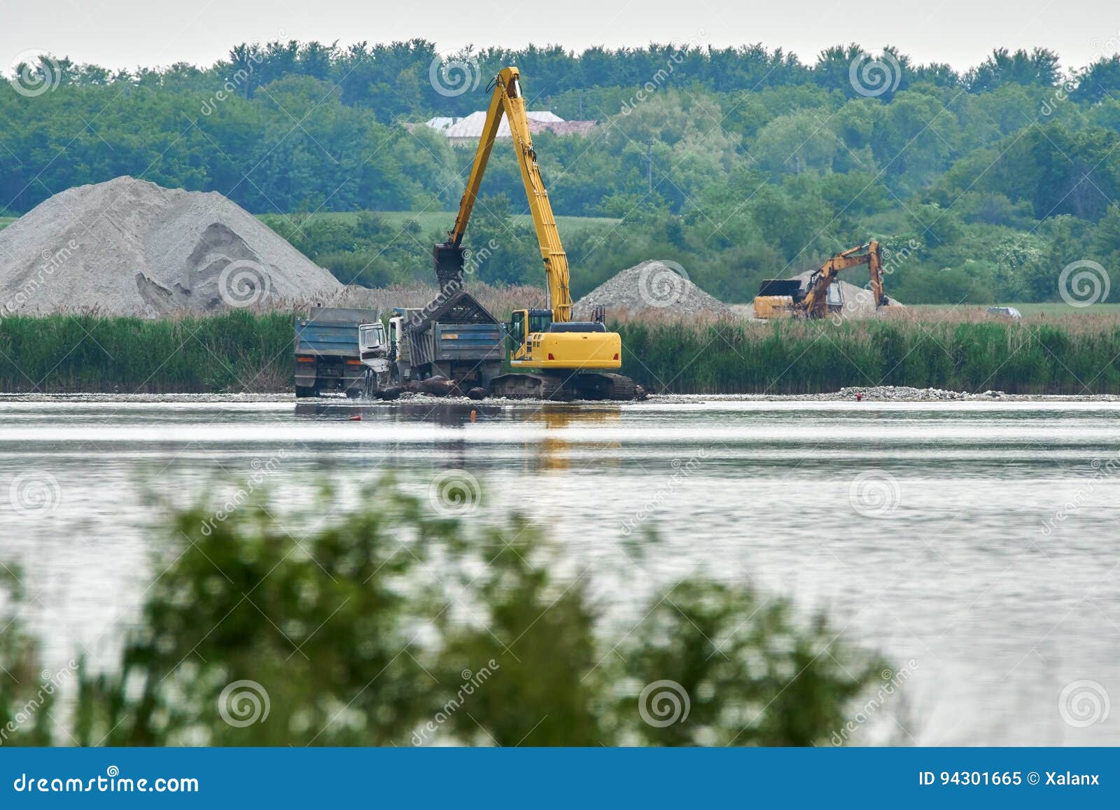 Excavator Loading a Truck on a Lake Stock Image - Image of heap ...