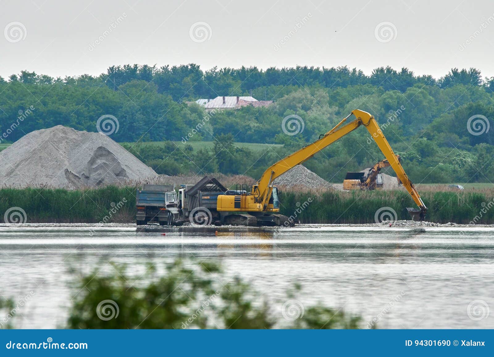 Excavator Loading a Truck on a Lake Stock Photo - Image of machine ...