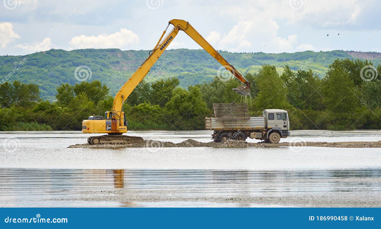 Excavator Loading a Truck on a Lake Stock Photo - Image of ground, dirt ...