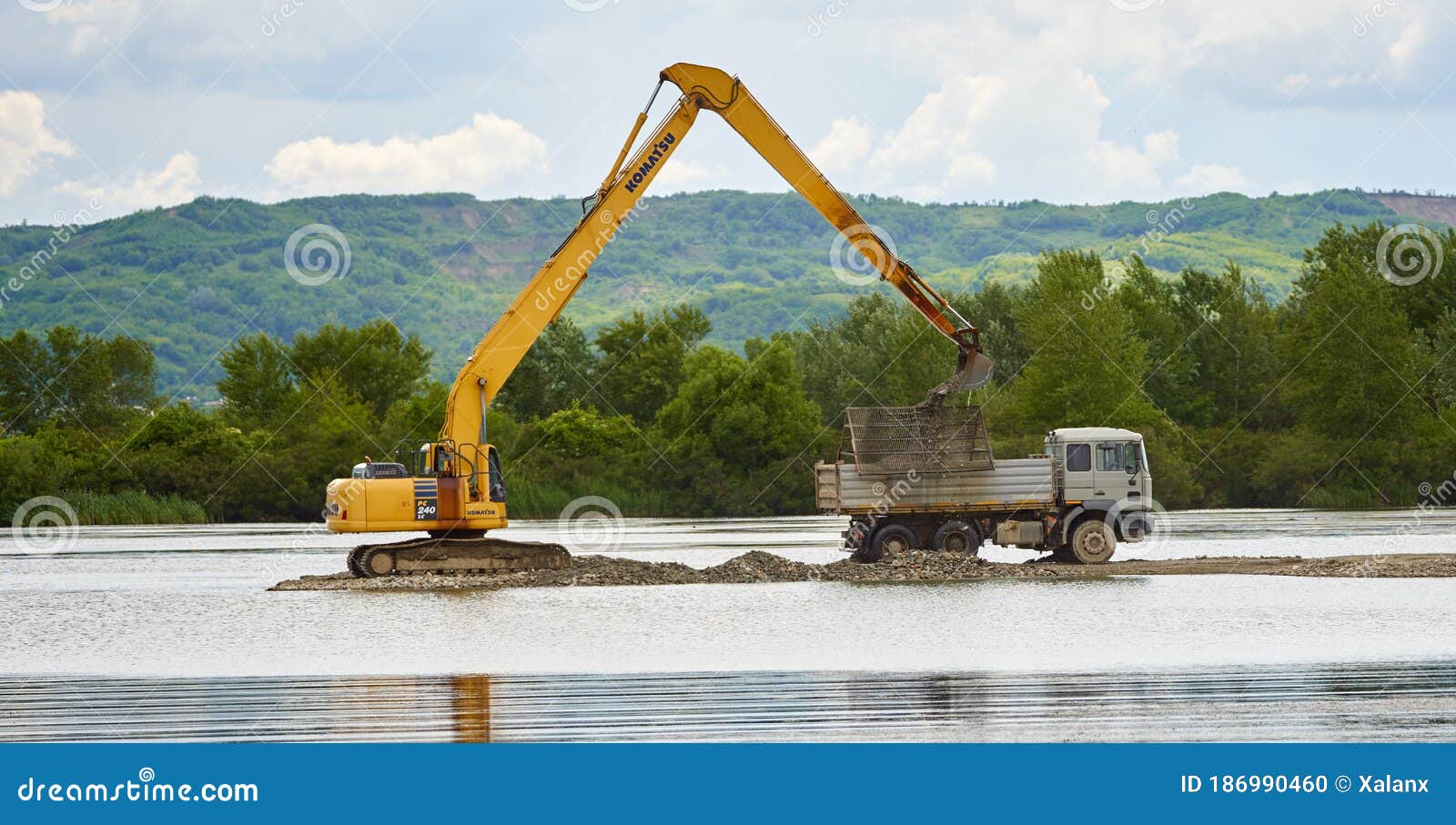 Excavator Loading a Truck on a Lake Stock Photo - Image of construction ...