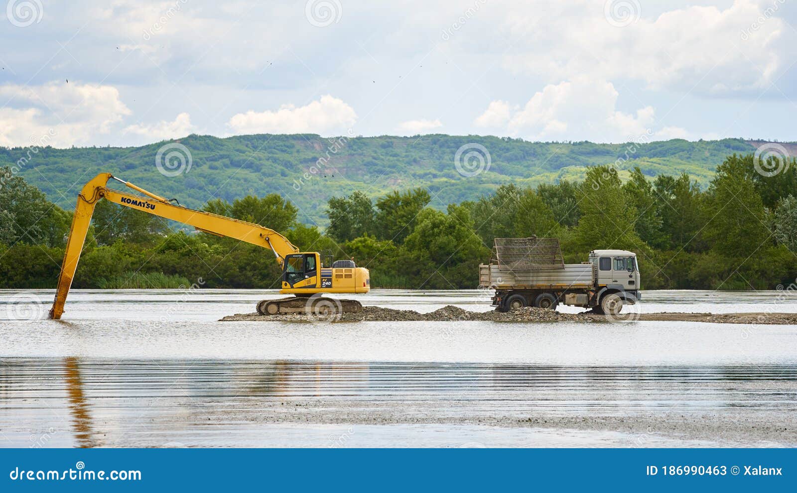 Excavator Loading a Truck on a Lake Stock Image - Image of bucket ...