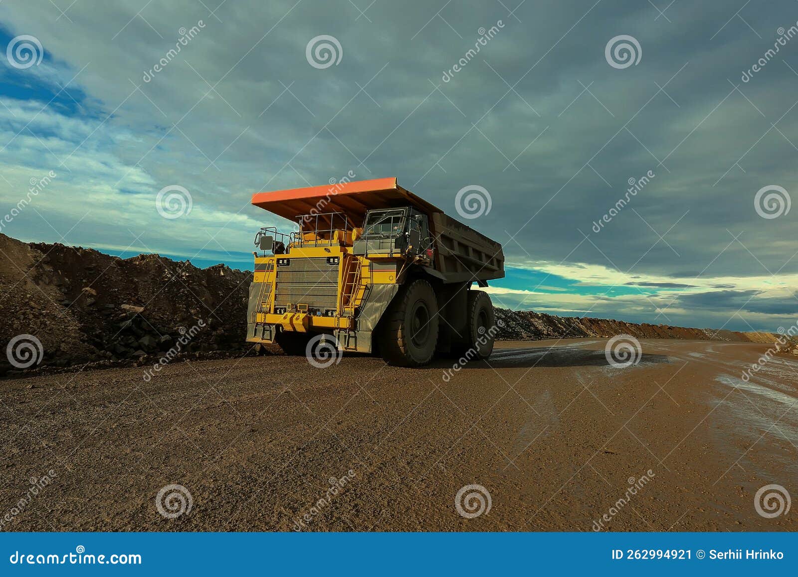 The Excavator is Loading a Yellow Mining Truck. Open Pit Mining ...