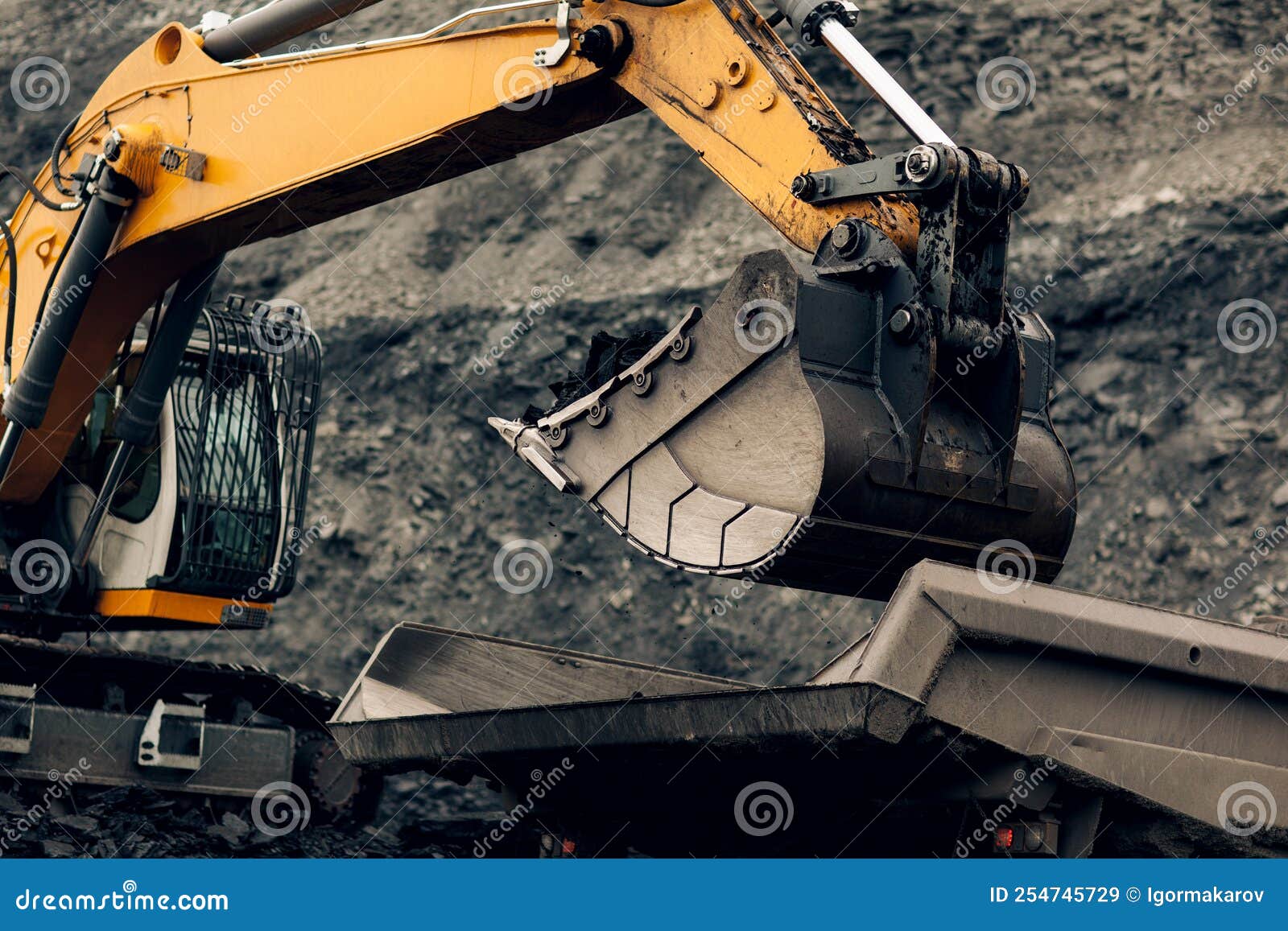 Excavator Loads Coal into the Back of a Heavy Mining Dump Truck. Stock ...