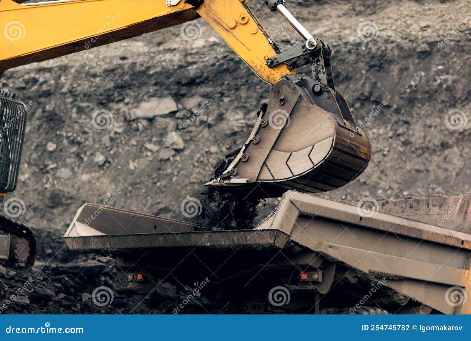 Excavator Loads Coal into the Back of a Heavy Mining Dump Truck. Stock ...