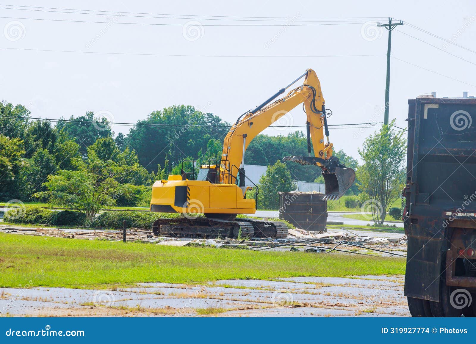 An Excavator Loads Construction Waste Concrete into a Dump Container ...