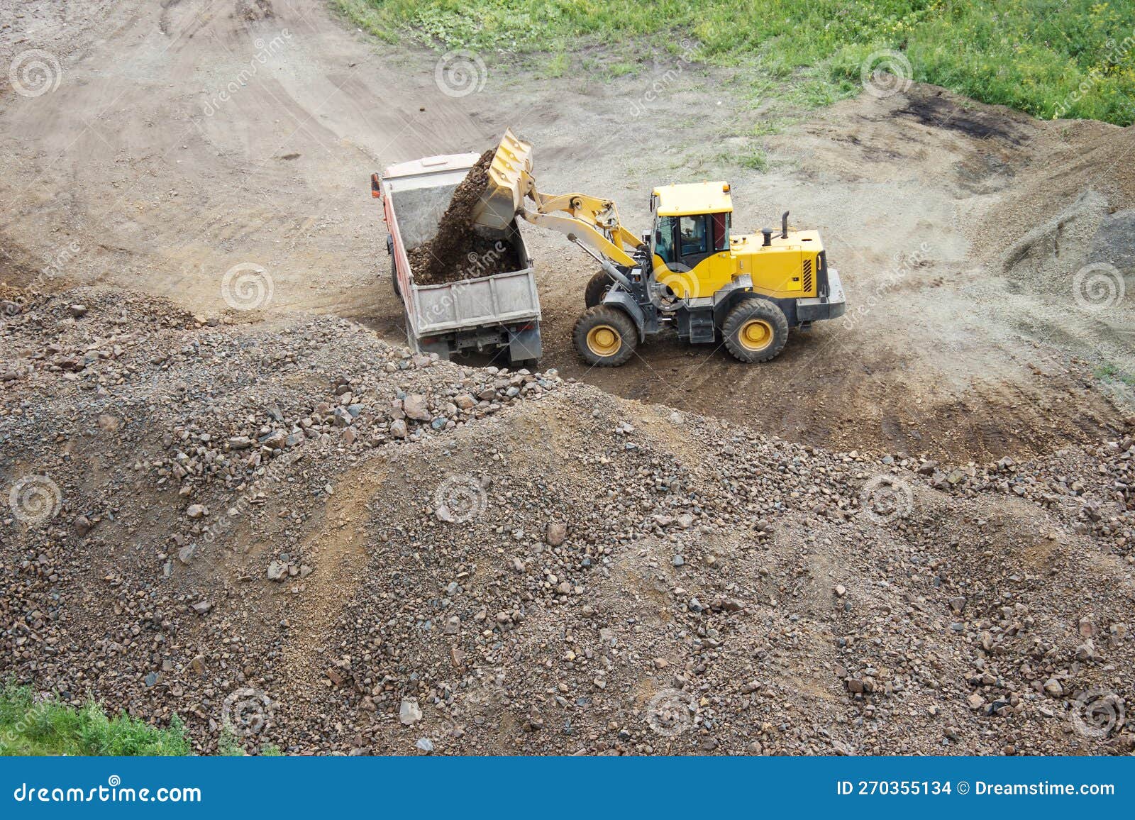 Excavator Loads Crushed Stone into Dump Truck Stock Photo - Image of ...
