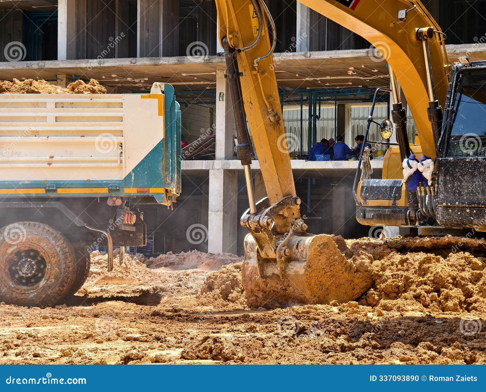 Excavator Loads Ground into a Dump Truck at a Construction Site Stock ...
