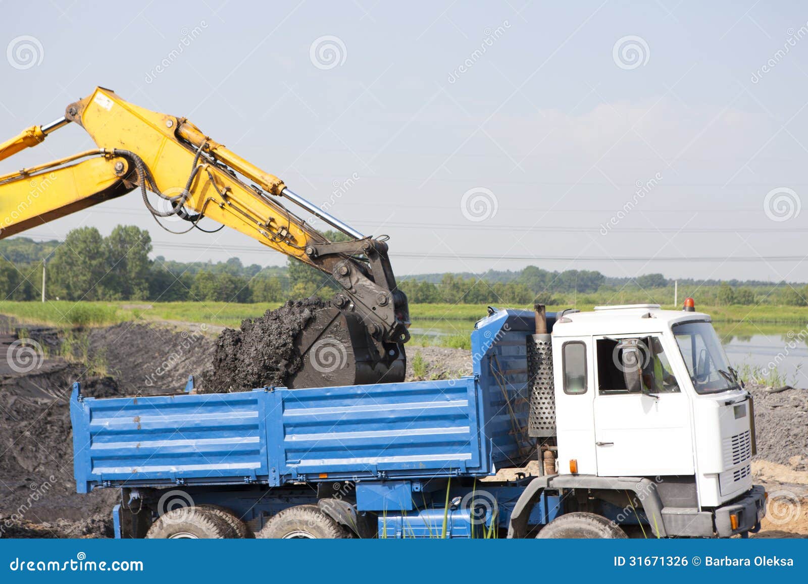 Excavator and lorry stock photo. Image of charging, load - 31671326