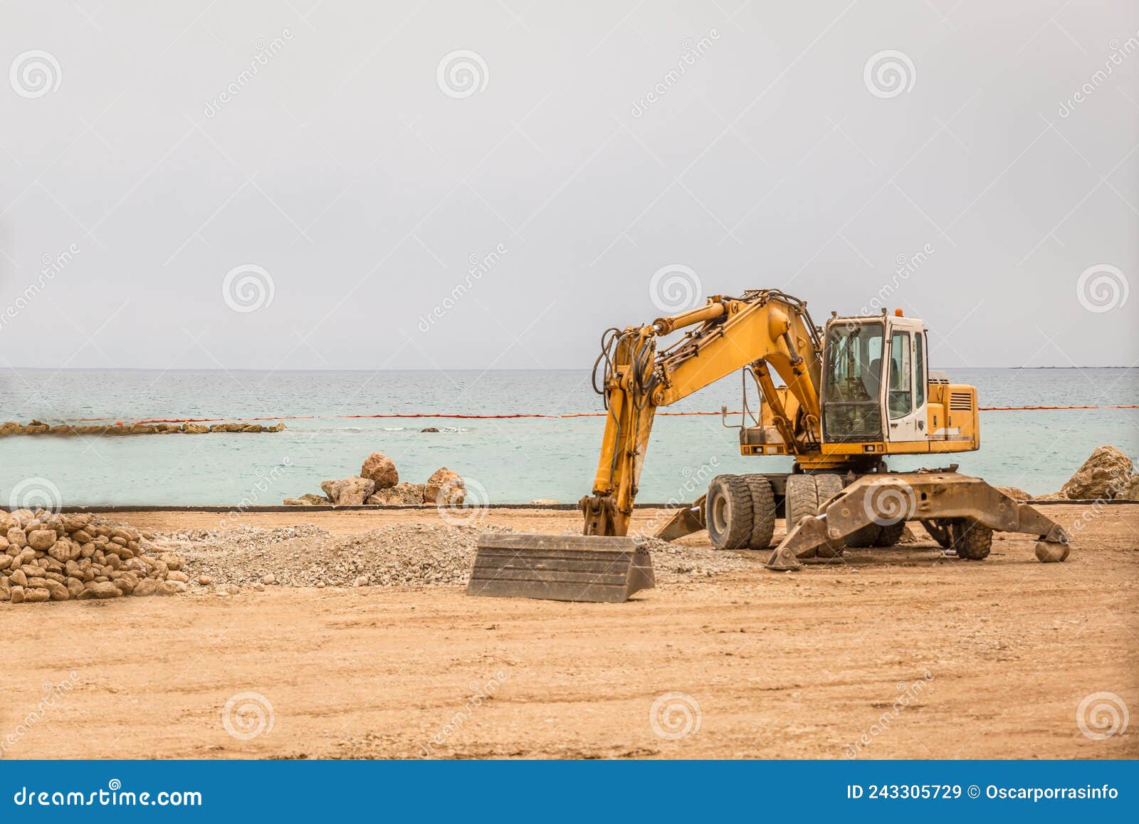 Excavator Machine on a Beach Collecting Sand for a Construction Stock ...