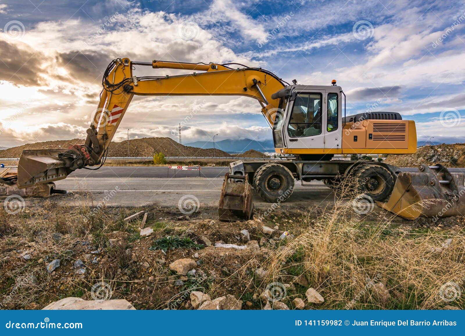 Excavator Machine Carrying Out Road Maintenance Works Stock Photo ...