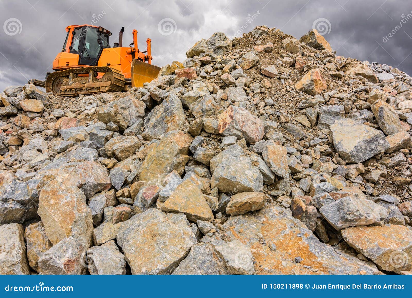Excavator Moving Rock in a Quarry Stock Photo - Image of landscape ...