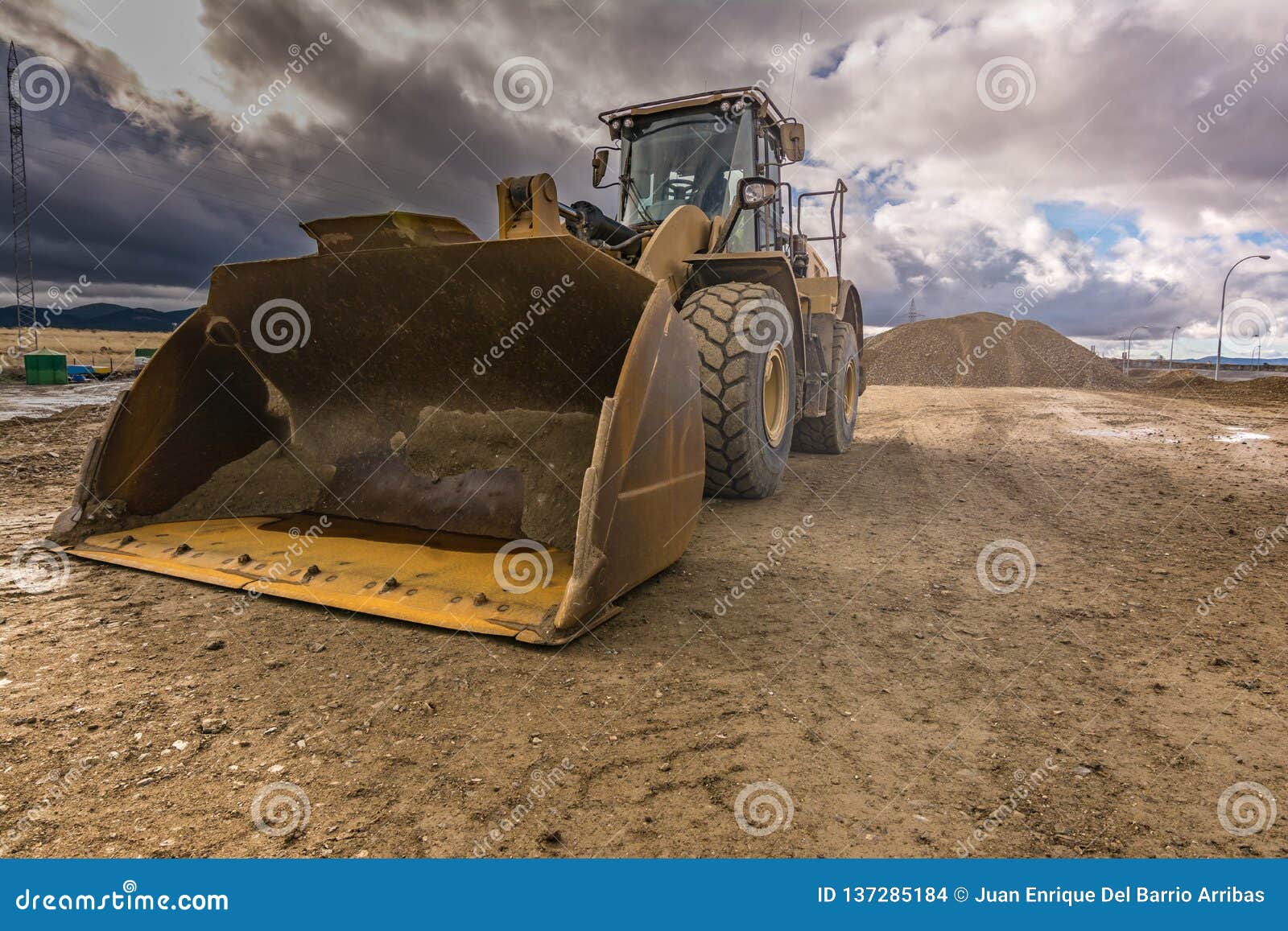 Excavator Performing Loading and Unloading of Sand in a Construction ...