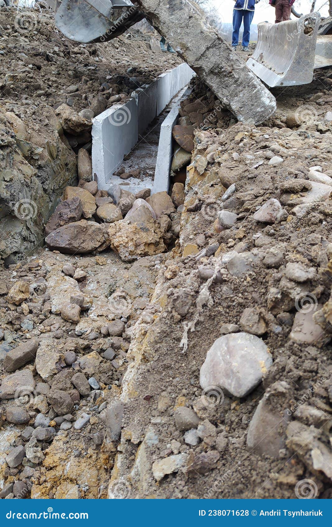 The Excavator Puts Concrete Slabs for Moving through the Gutter ...