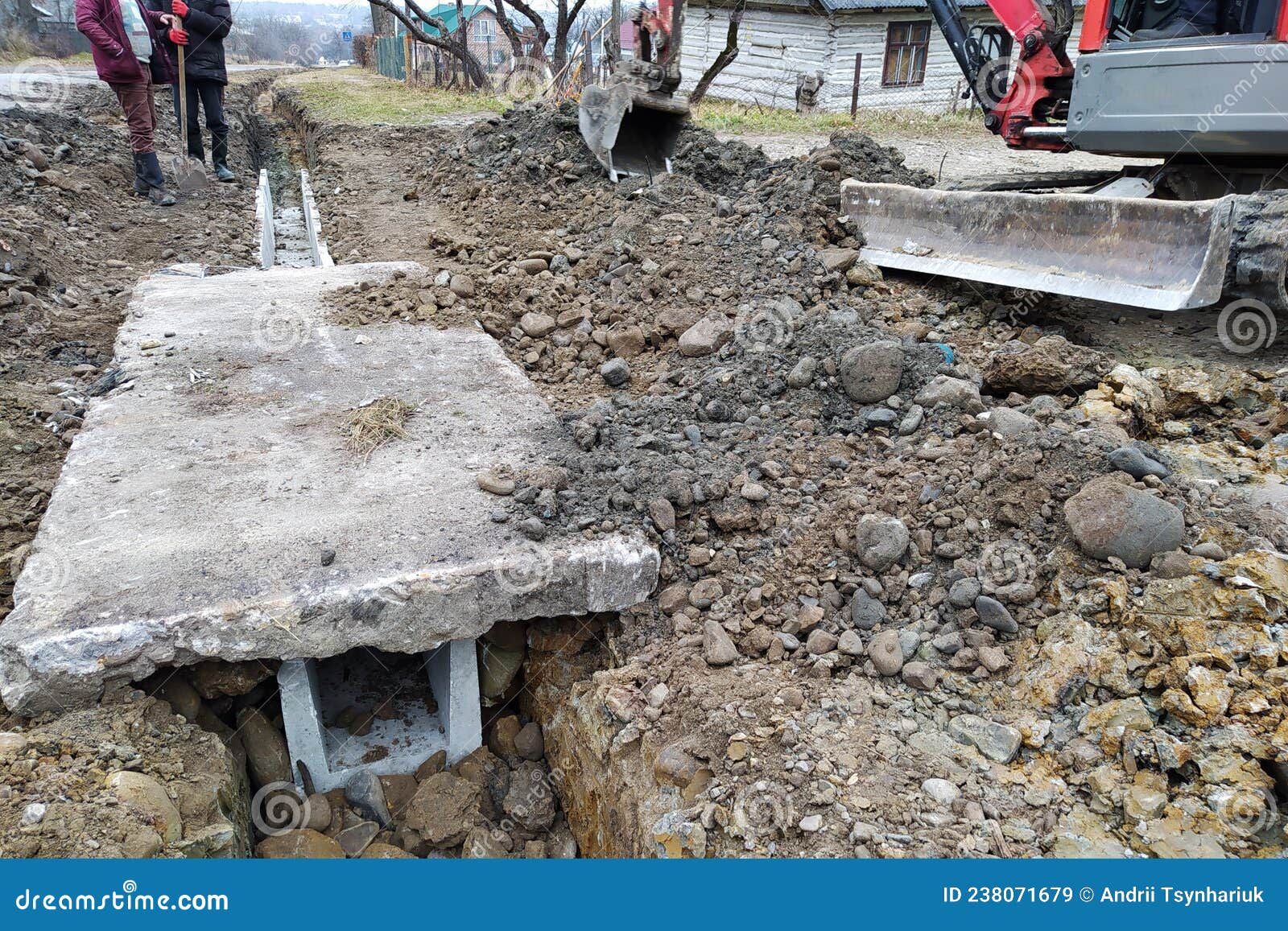 The Excavator Puts Concrete Slabs for Moving through the Gutter ...