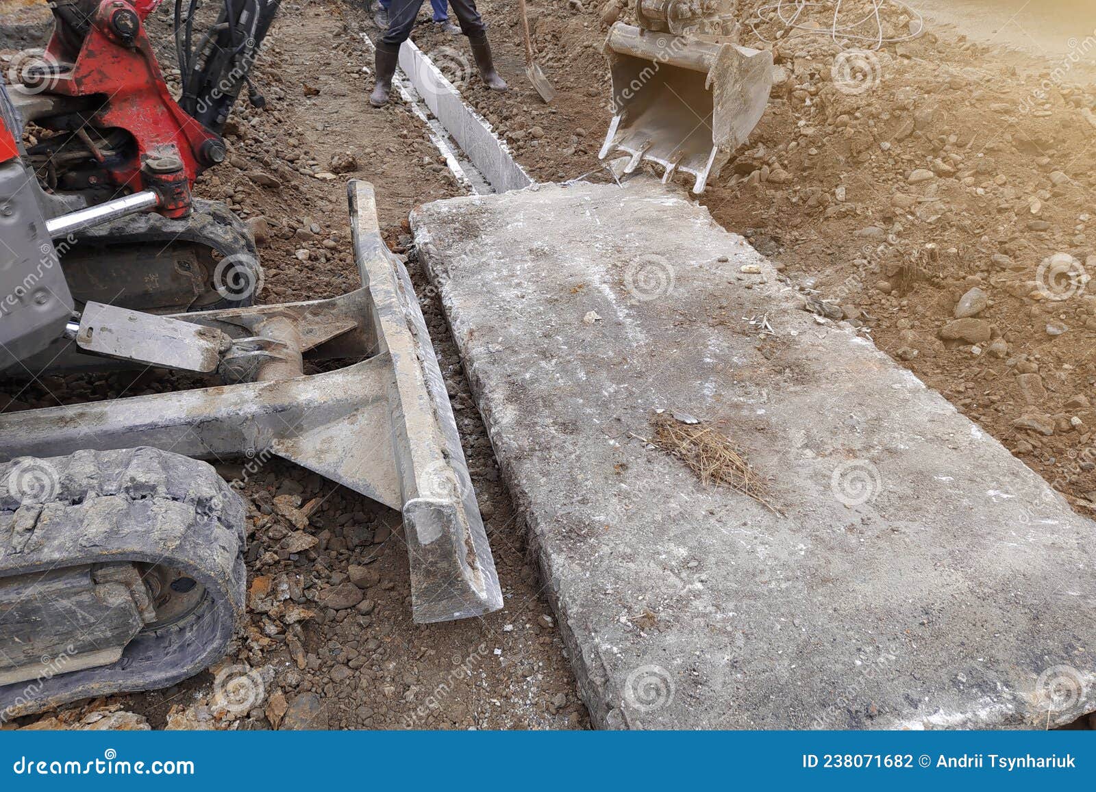 The Excavator Puts Concrete Slabs for Moving through the Gutter ...
