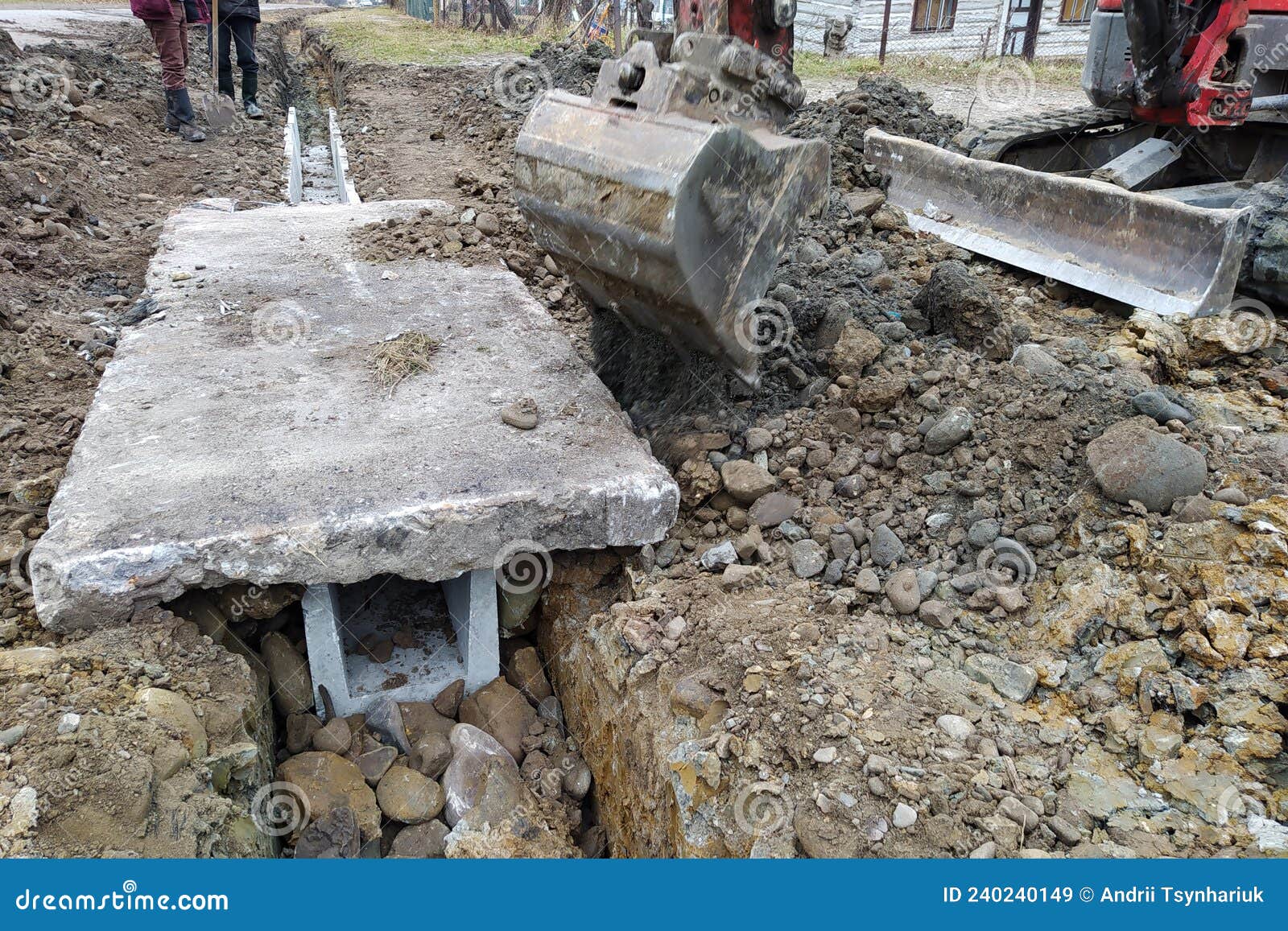 The Excavator Puts Concrete Slabs for Moving through the Gutter ...