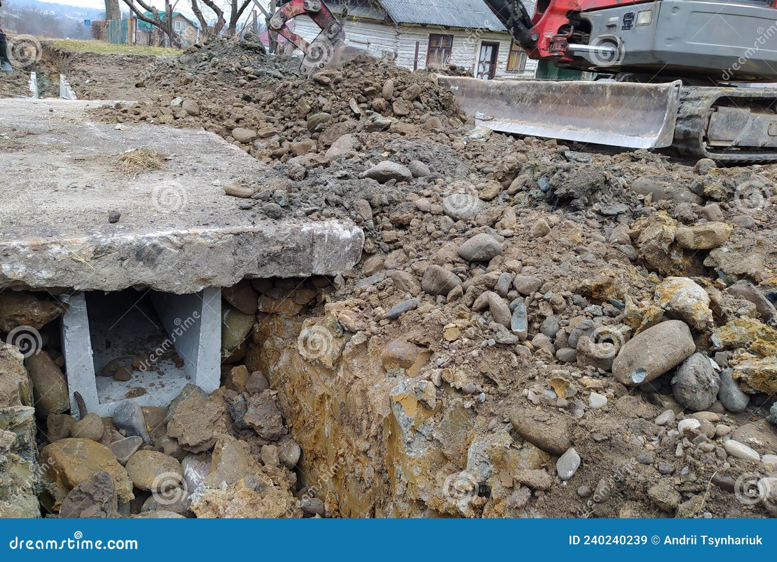 The Excavator Puts Concrete Slabs for Moving through the Gutter ...