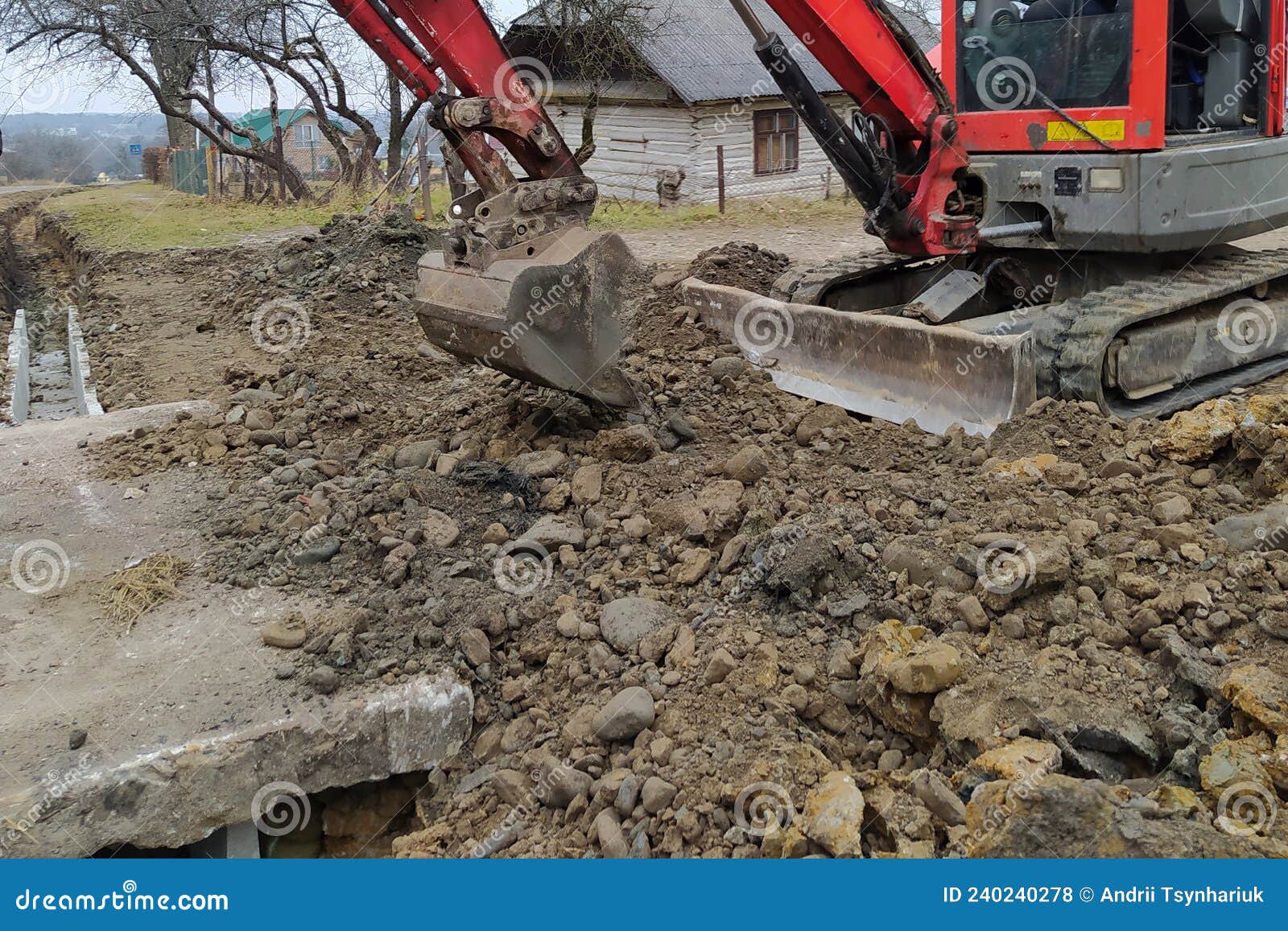 The Excavator Puts Concrete Slabs for Moving through the Gutter ...