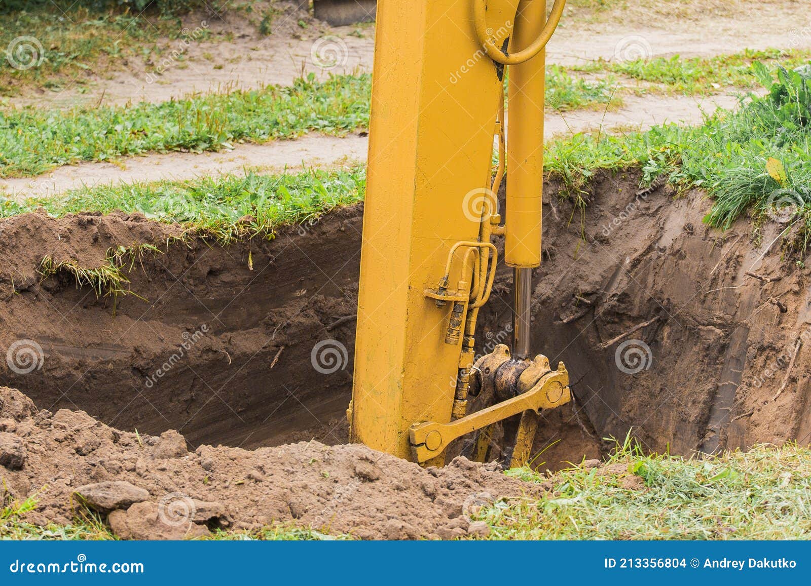 The Excavator`s Hydraulic Piston Digs Deep into the Pit with a ...