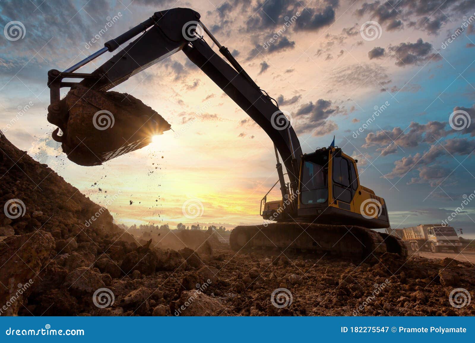 Excavator During Earthmoving At Construction Site On Sunset Background ...