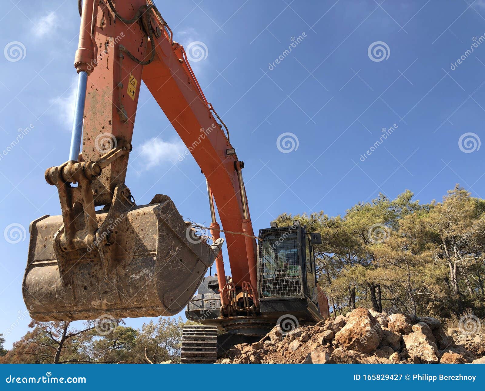 Excavator Scoop Loading a Soil during Road Construction. Load Angle ...
