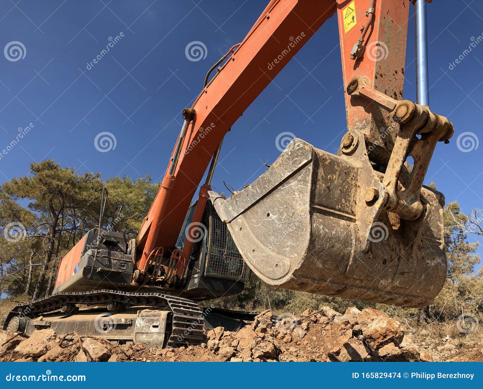 Excavator Scoop Loading a Soil during Road Construction. Load Angle ...