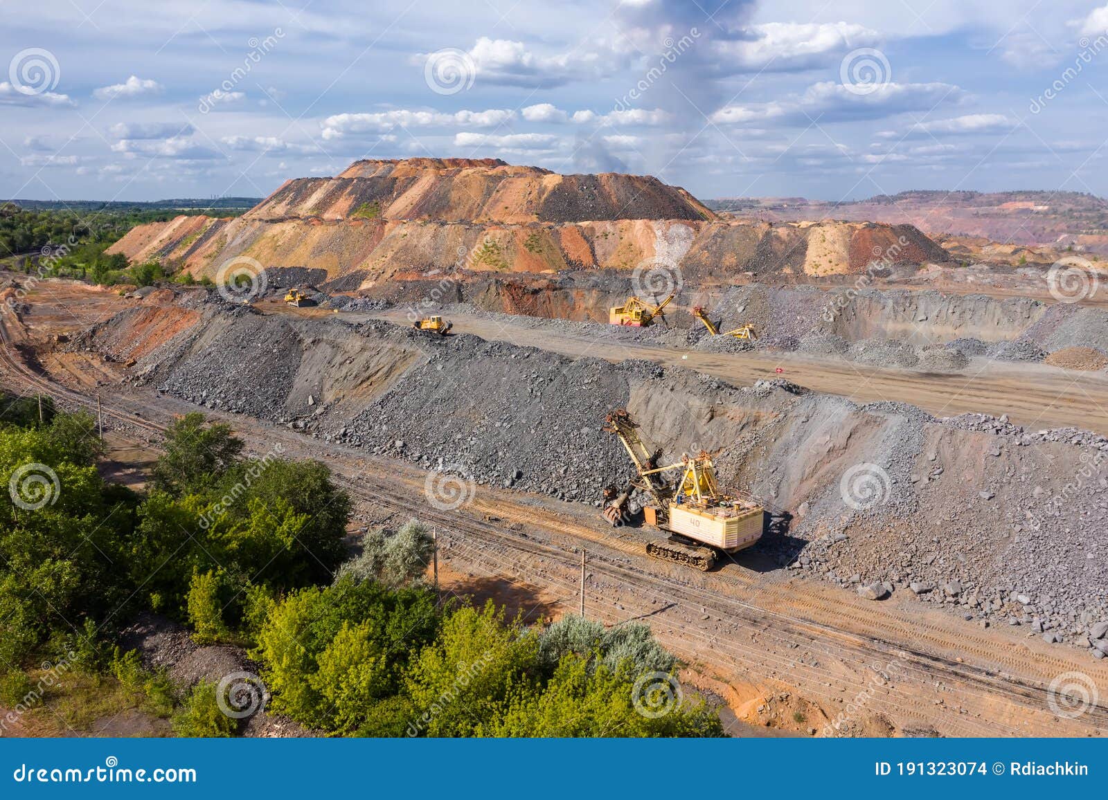 Excavator Stands Against the Backdrop of Mining Equipment at a Mining ...