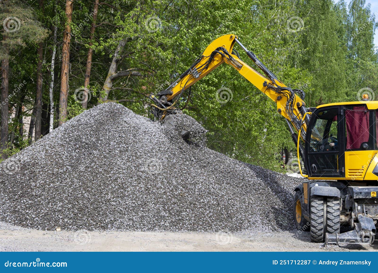Excavator Takes a Bucket of Crushed Stone from a Large Pile of Rubble ...