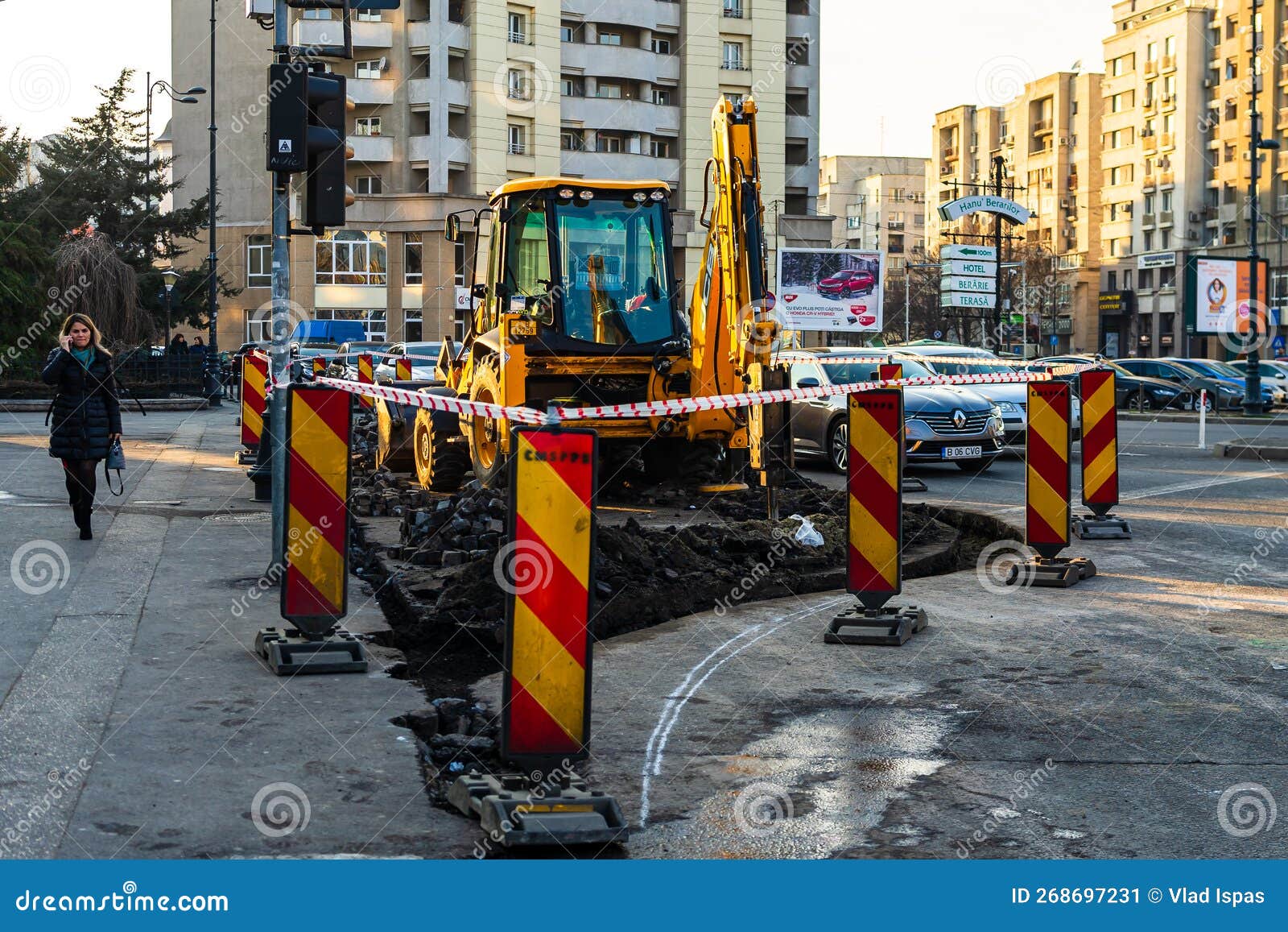 Excavator in Traffic. Industrial Equipment at Construction Site in Bucharest, Romania, 2023 ...