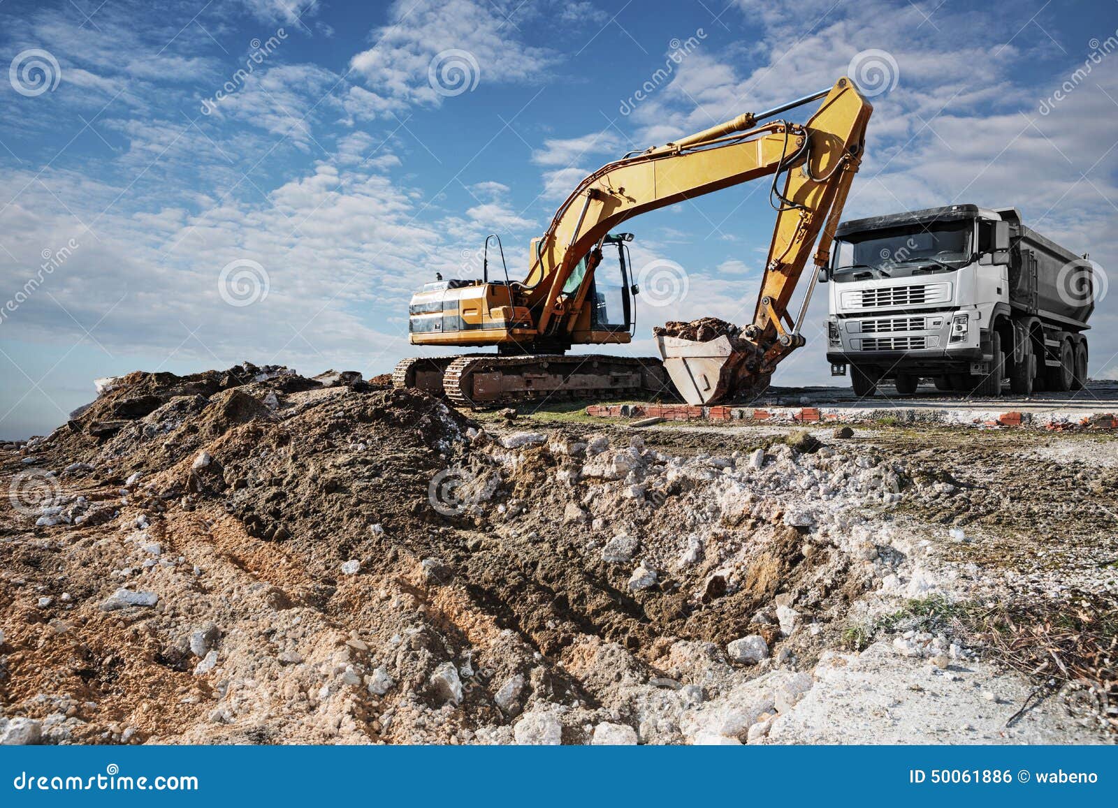 Excavator and Truck on a Construction Site Stock Photo - Image of ...