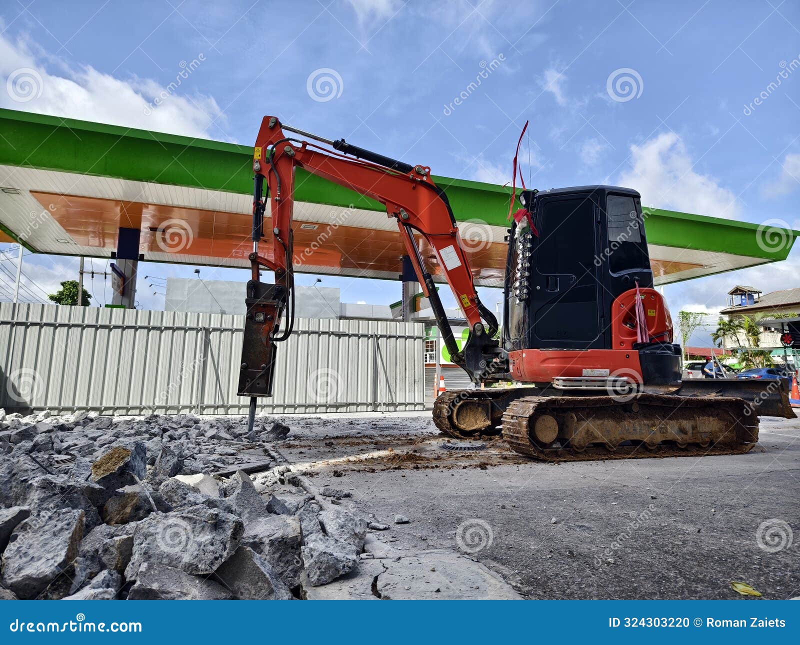 Excavator Using Hydraulic Hammer for Breaking Concrete at a ...