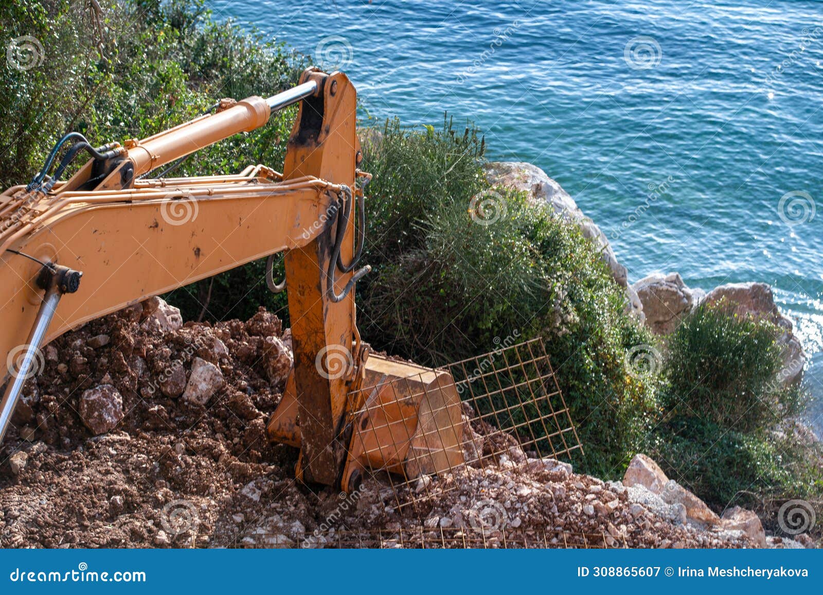 Excavator at Work on a Coastal Construction Site, with Sea in the ...