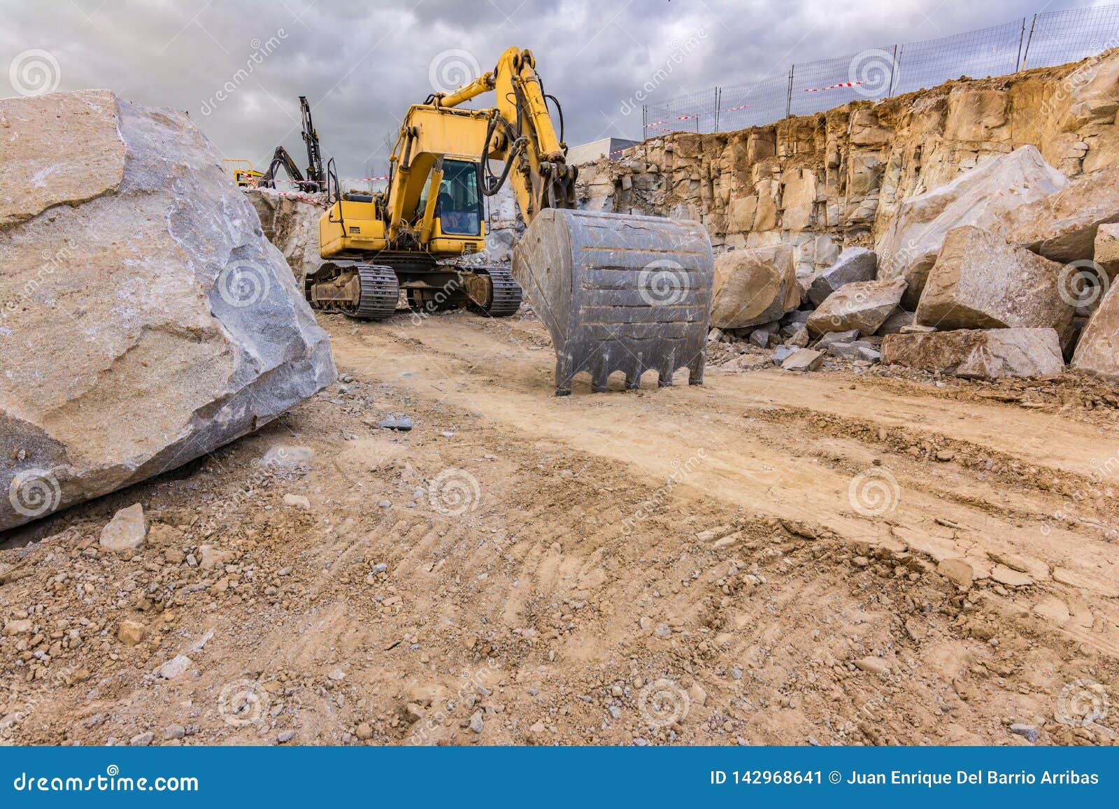 Excavator in a Work Extracting Granite To Transform into Gravel Stock ...