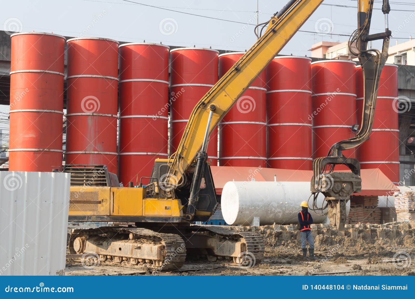 Excavator with Worker Working beside Red Drilling Solution Tanks at ...