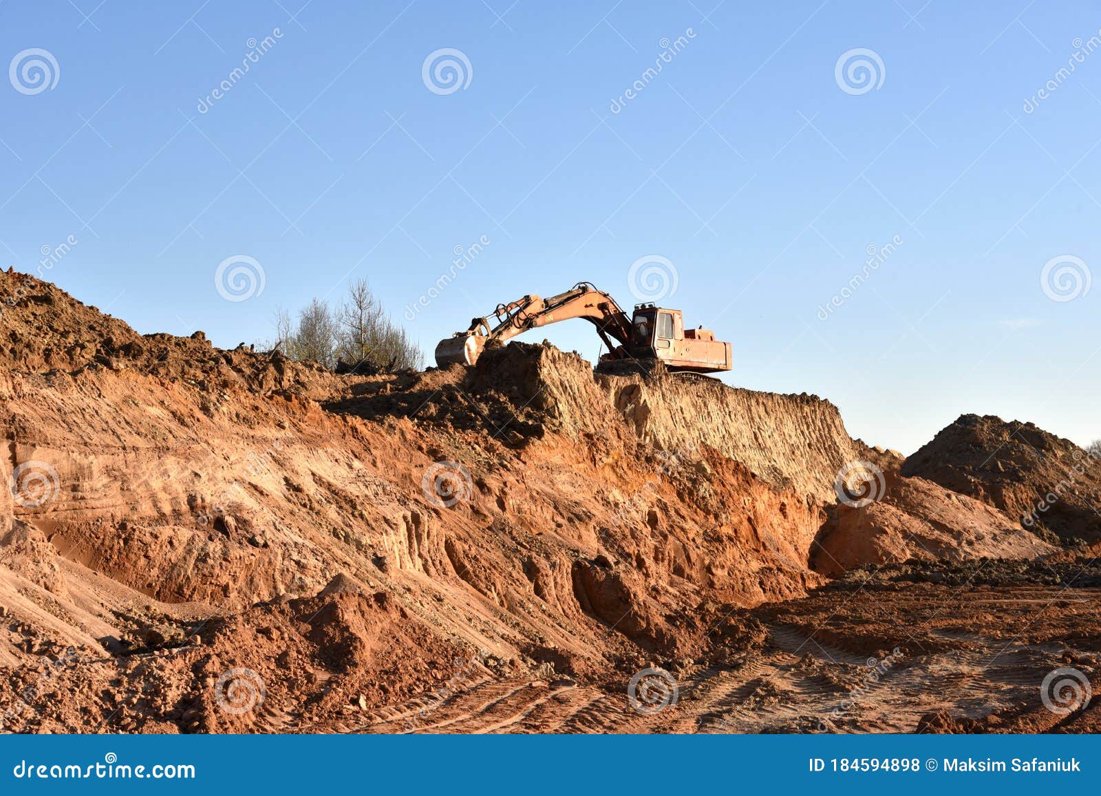 Excavator Working on Earthmoving at Open Pit Mining. Backhoe Digs ...