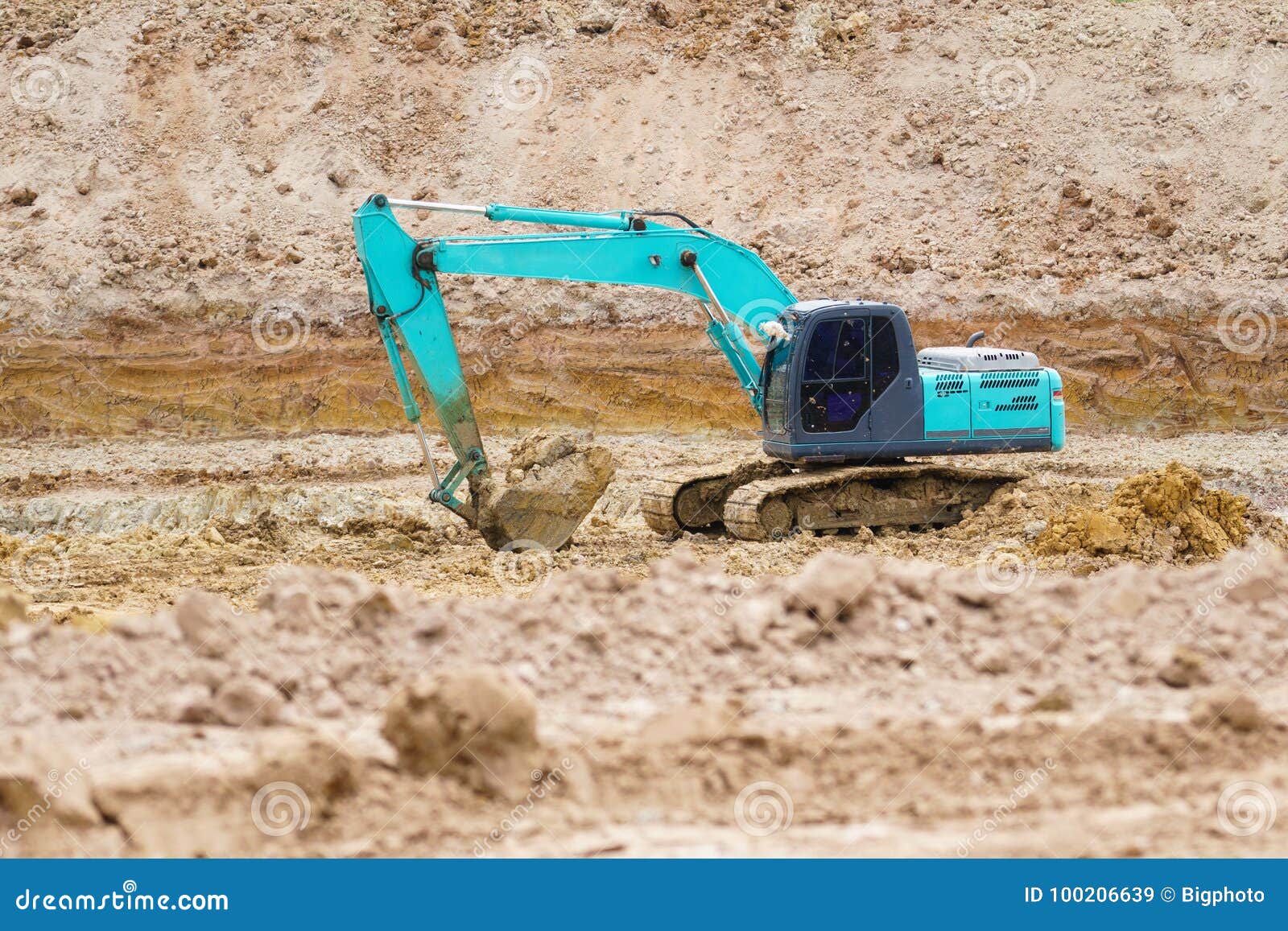 An Excavator Working Removing Earth on a Construction Site. Stock Image ...
