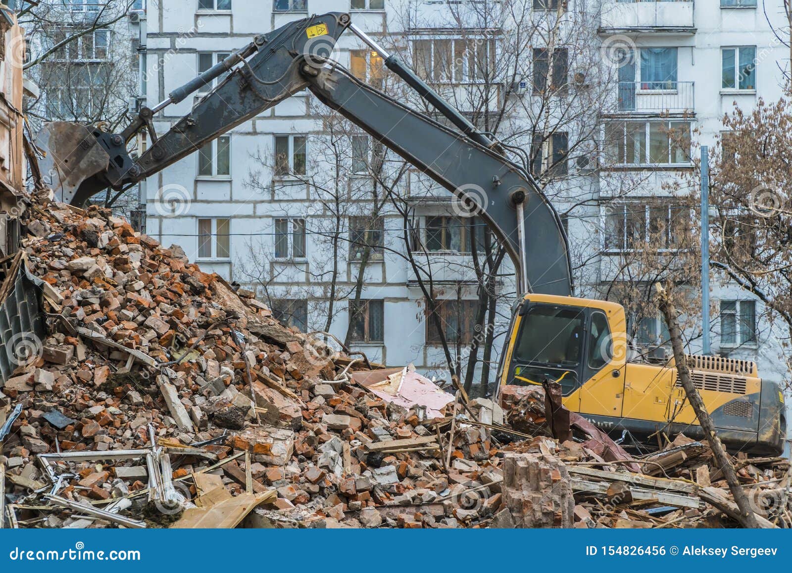 Excavator Working on the Wreckage of the Building Stock Photo - Image ...