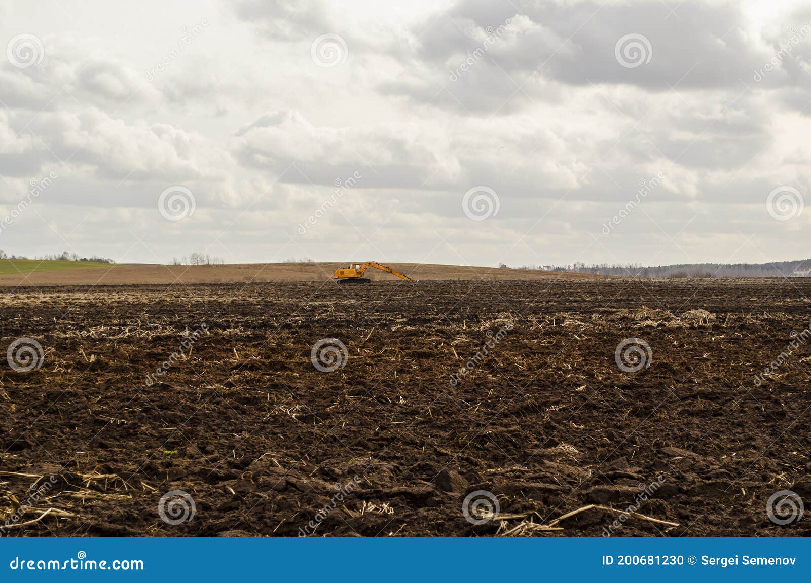 Excavator Works in the Field, Digs Trenches . Stock Photo - Image of ...