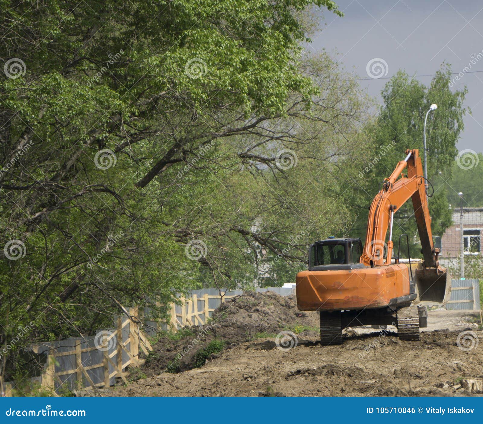 Excavators Are Digging The Soil In The Construction Site On The Sunset ...