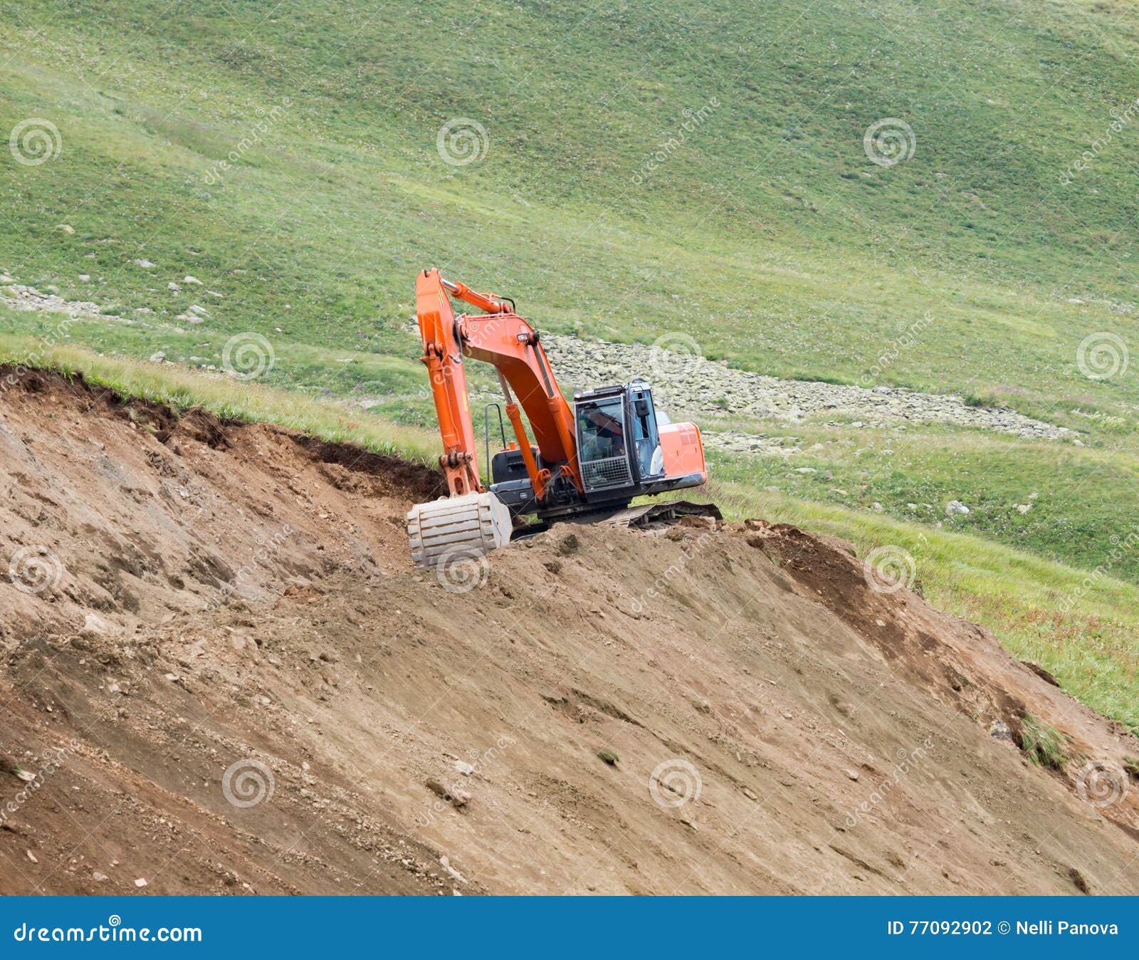 Excavators Digging the Ground in a Green Field Stock Photo - Image of ...