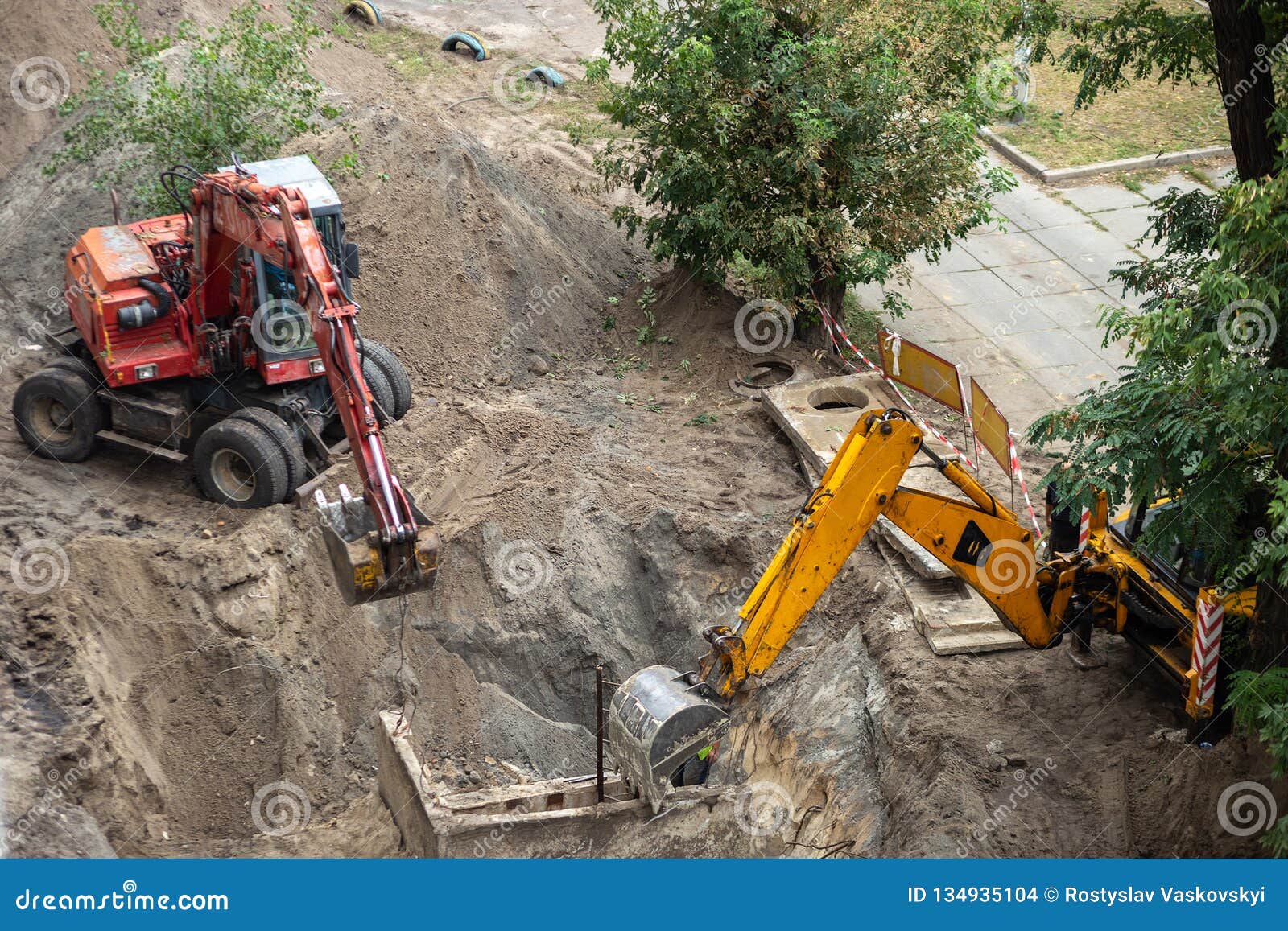 Excavators digging a pit stock photo. Image of site - 134935104