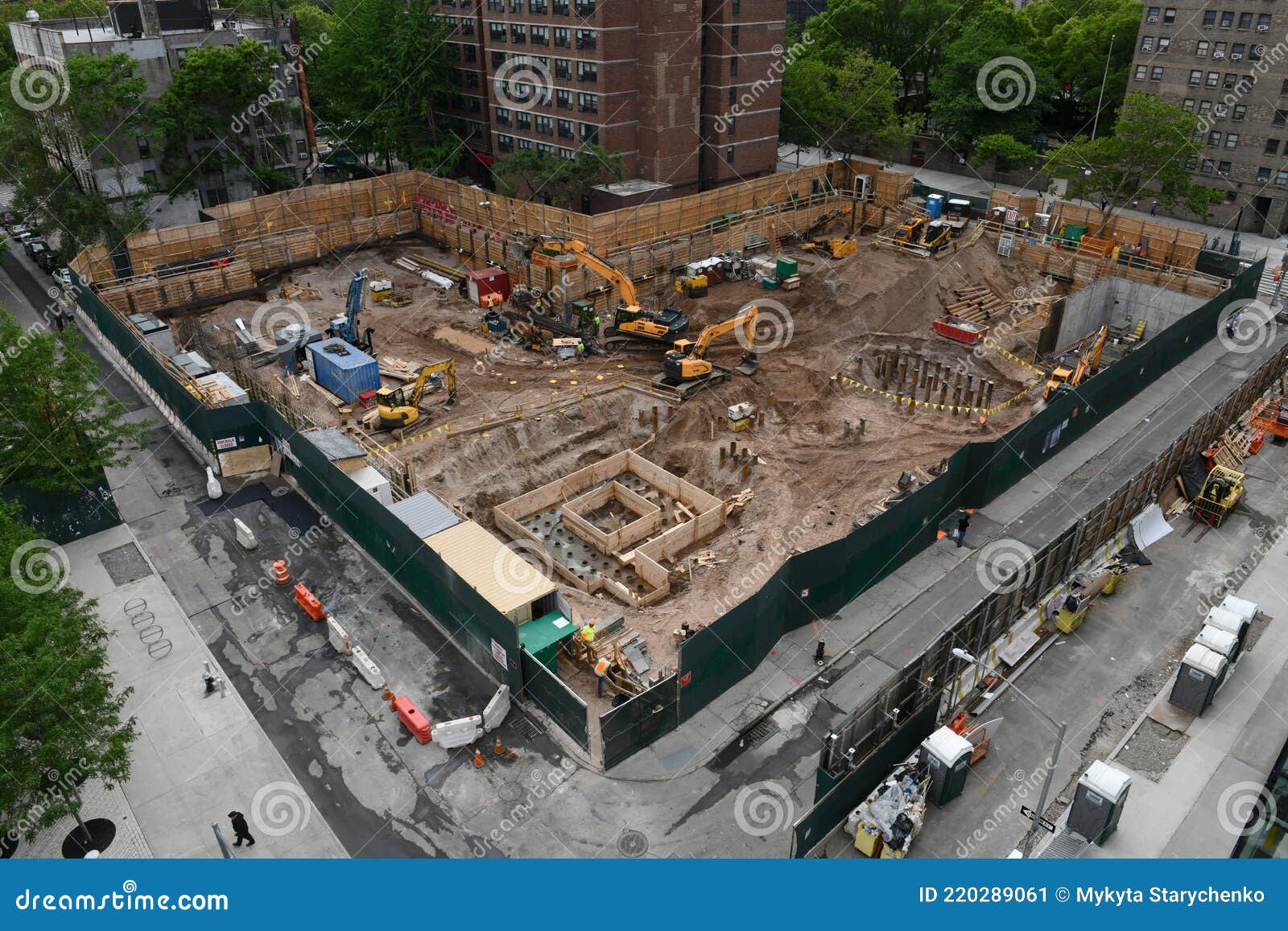 The Excavators On The Construction Site Against The Background Of A ...
