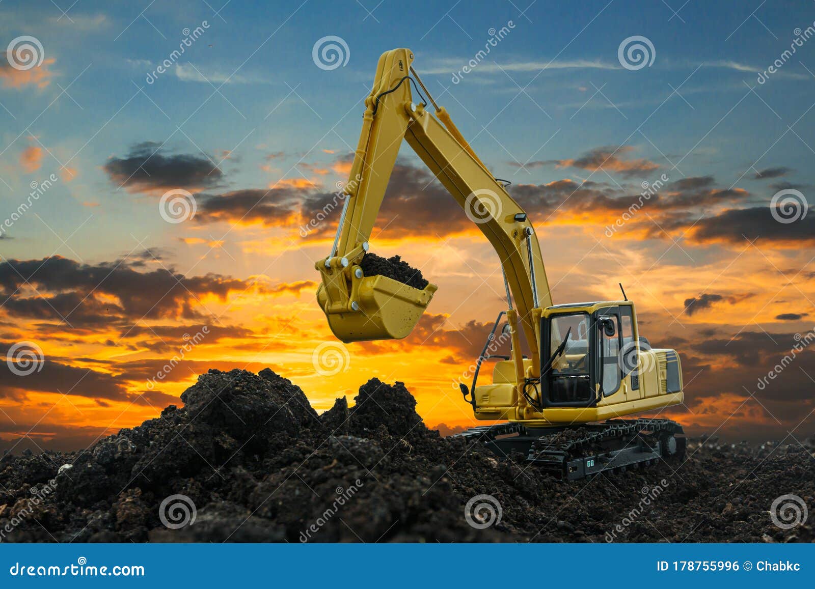 Excavators Are Digging The Soil In The Construction Site On The Sunset ...