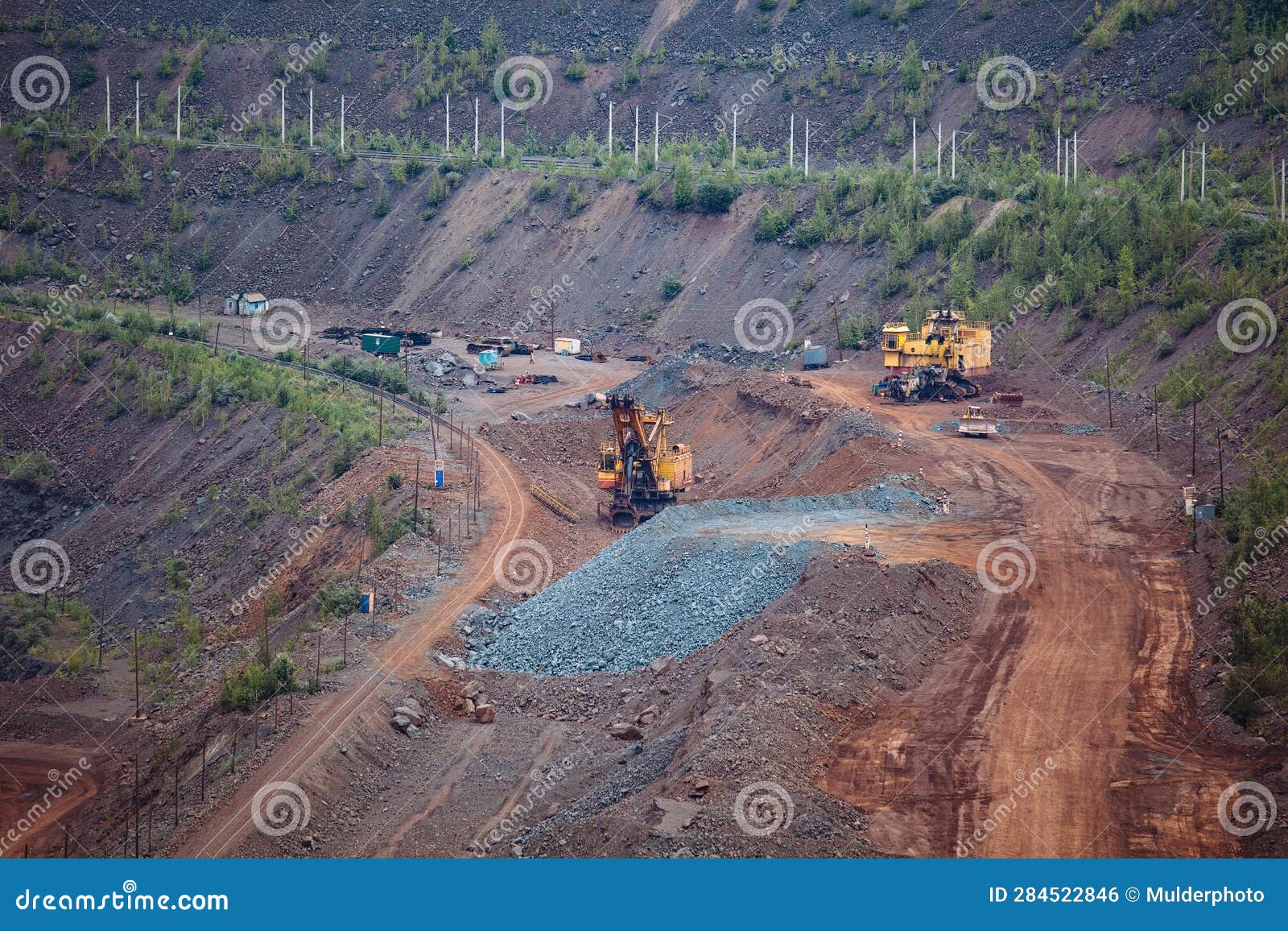 Excavators and Dump Trucks Working on Earthmoving at Open Pit Mine in ...