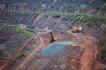 Excavators and Dump Trucks Working on Earthmoving at Open Pit Mine in ...