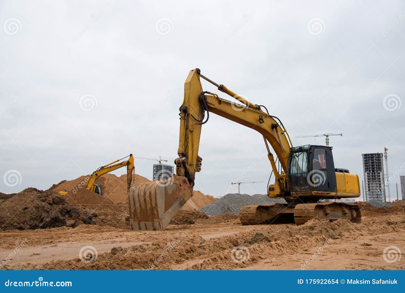 Excavators at Earthworks on Construction Site. Backhoe Loader Digs a ...
