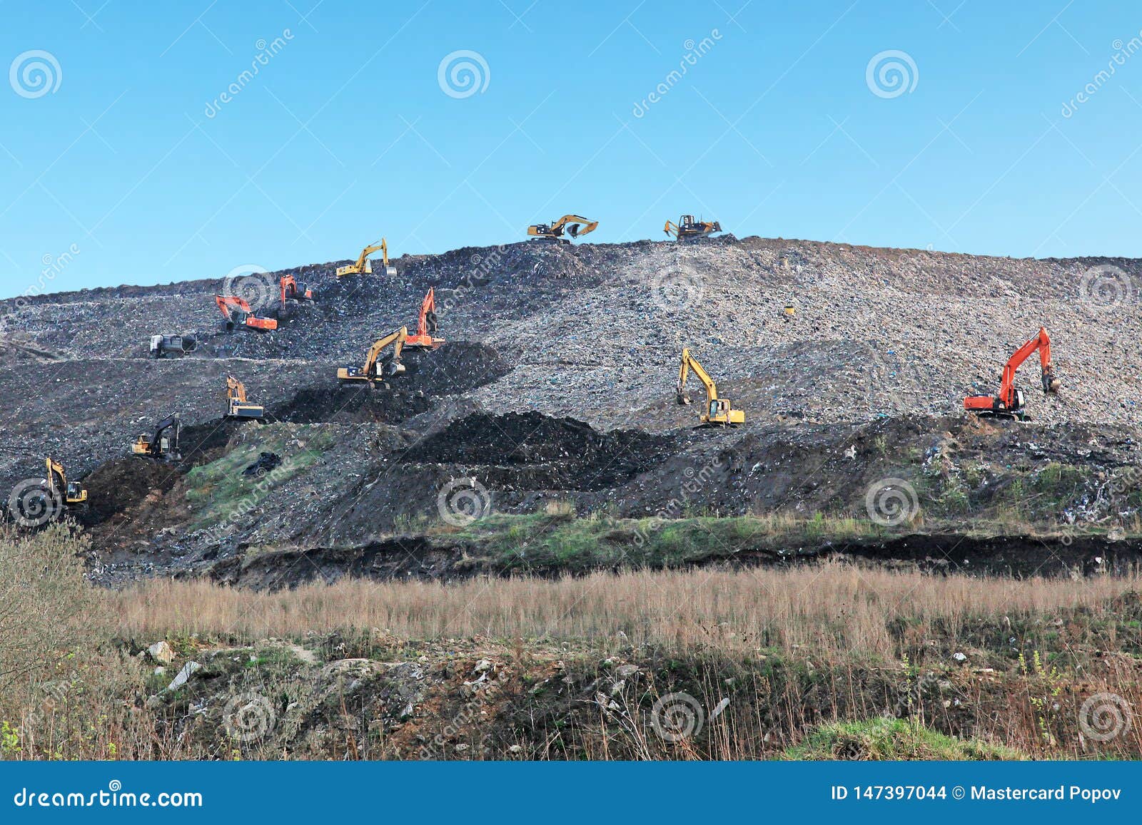 Excavators at work stock photo. Image of crushed, landfill - 147397044